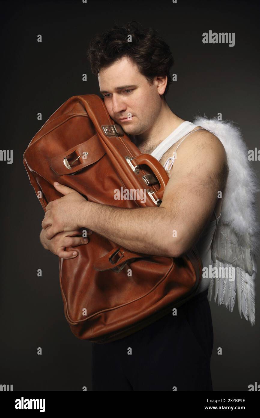 Mr. Angel with brown bag. Creepy character portrait Stock Photo - Alamy