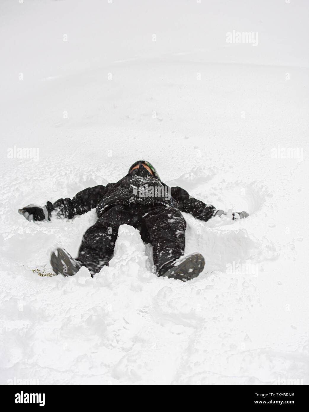 Child making a snow angel in the winter Stock Photo - Alamy