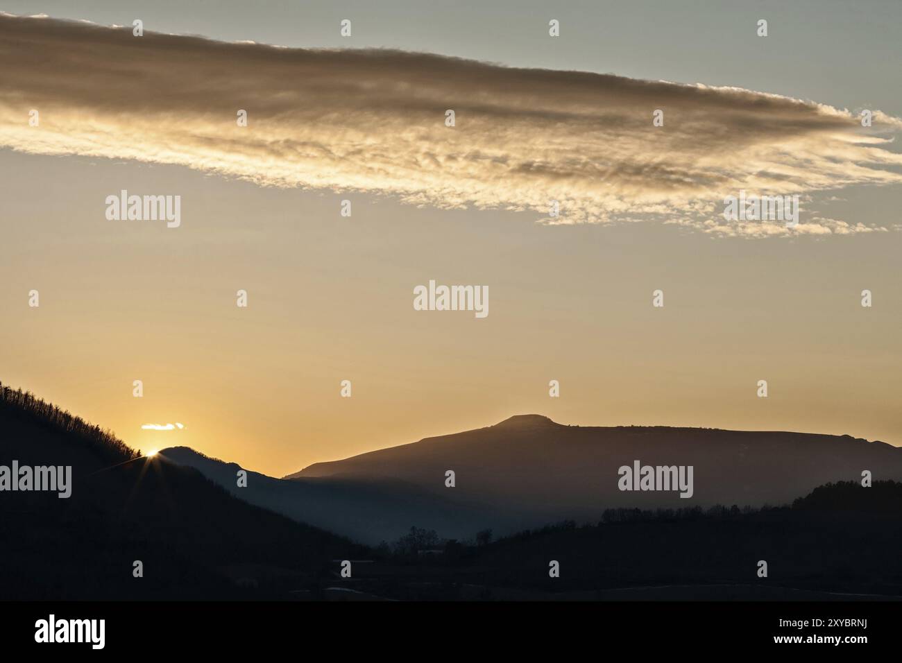 Sunset in the mountain landscape with sunny beams and golden sky Stock ...
