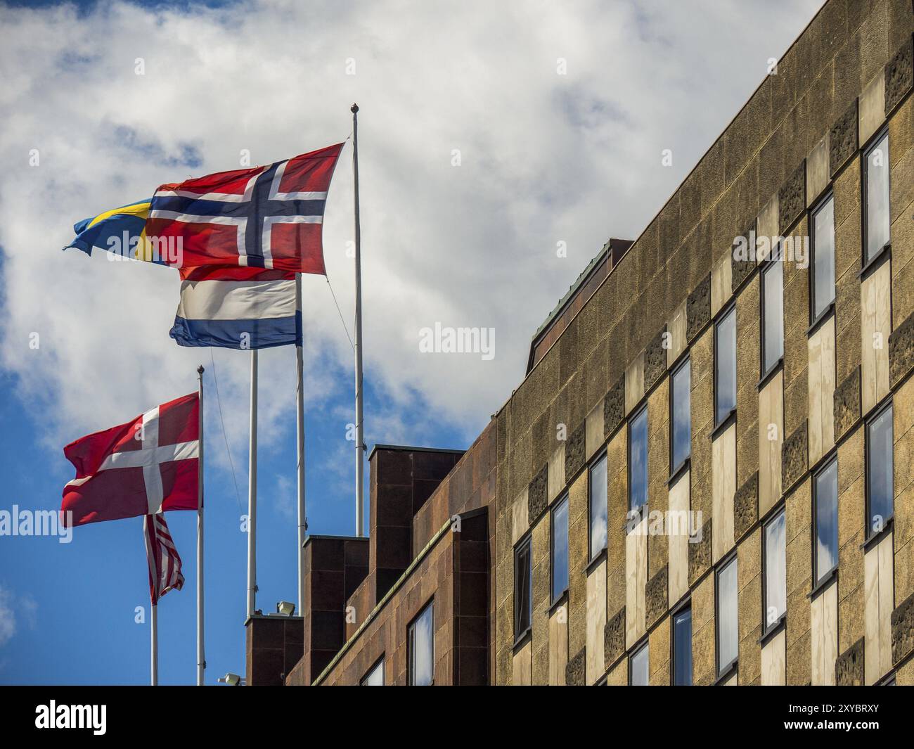 National flags of scandinavian countries fly in front of a building ...