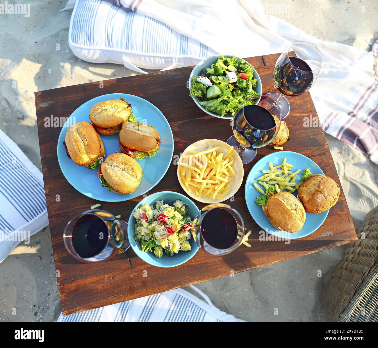 Beach summer picnic table with red wine glasses Stock Photo - Alamy