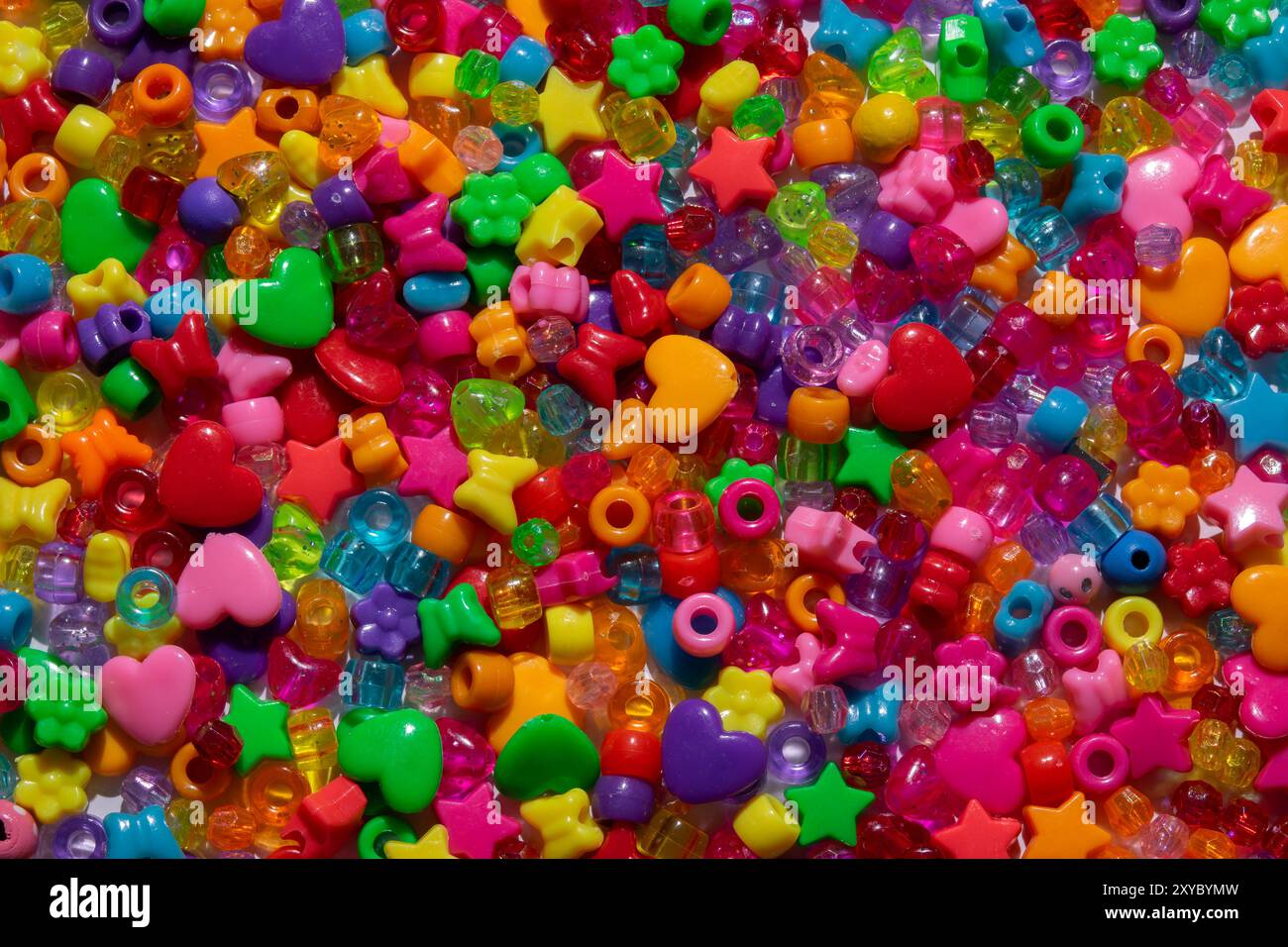 A large mound of various colorful beads scattered together in a ...