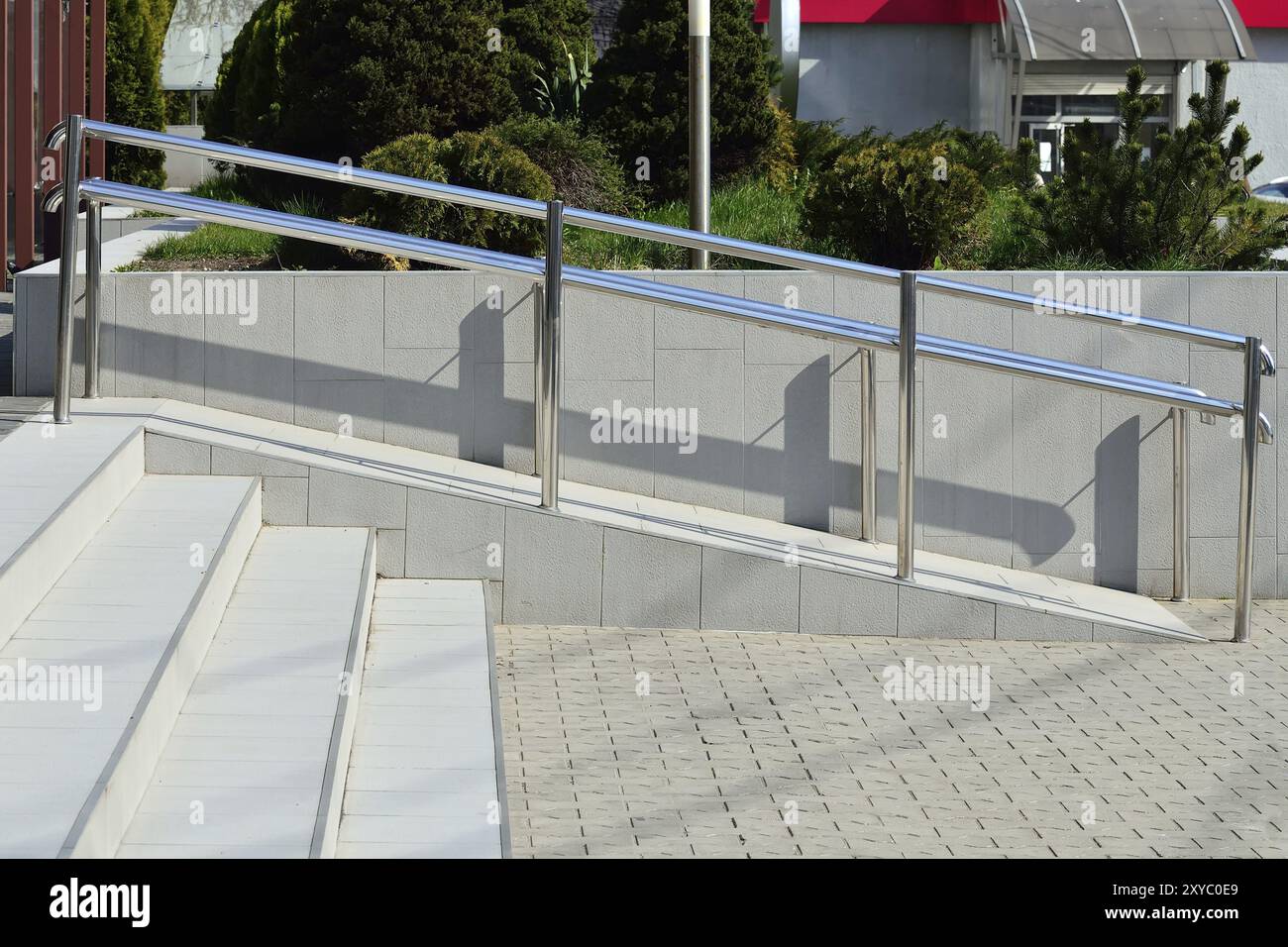 Ramp for wheelchair entry with metal handrails Stock Photo - Alamy