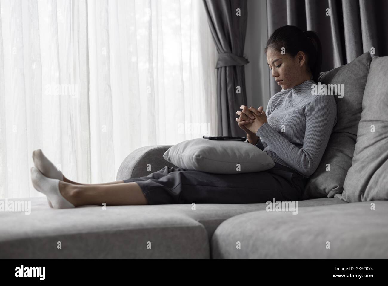 Depressed woman, person sitting alone on the sofa felling sad worry ...