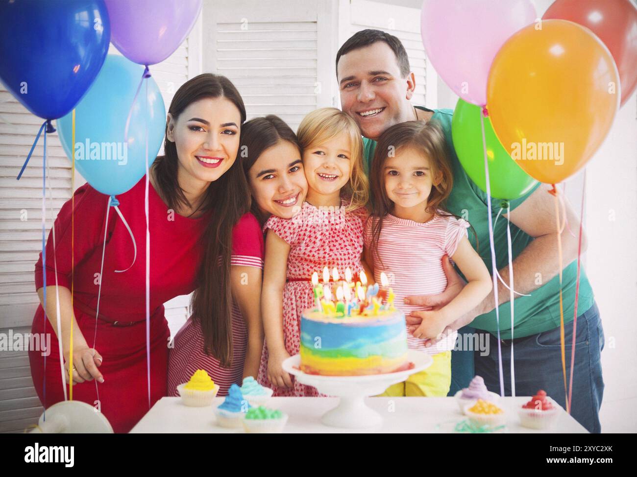 Portrait of a family celebrating birthday of their little daughter ...
