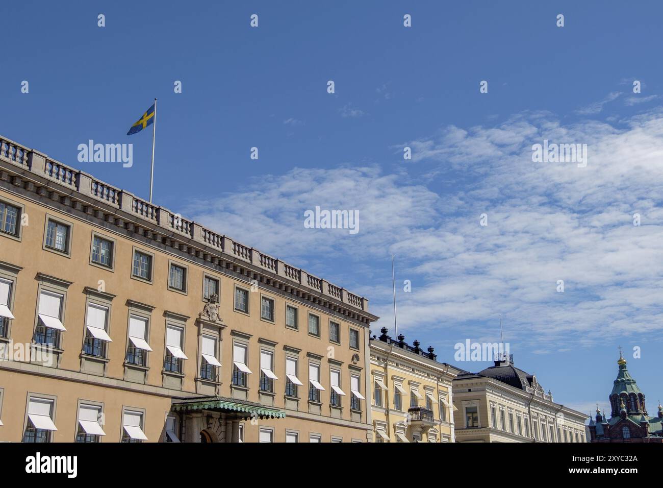 Upper floors of historic buildings under a blue sky with a flag and ...