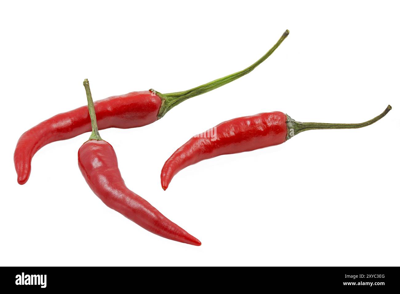 Three chilli peppers on a white background Stock Photo - Alamy