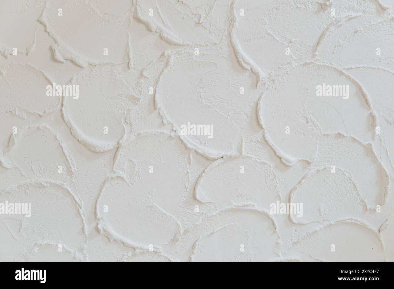 Photography of a wall covered in white paint or cement with a textured ...