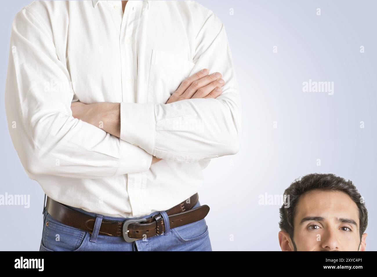 Height difference between two men in a blue background Stock Photo - Alamy