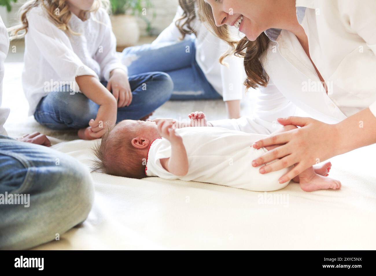 Big family with three kids in white living room. Parents and kids ...