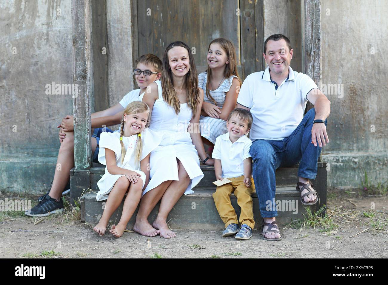 Happy family with five children outdoor near house Stock Photo - Alamy