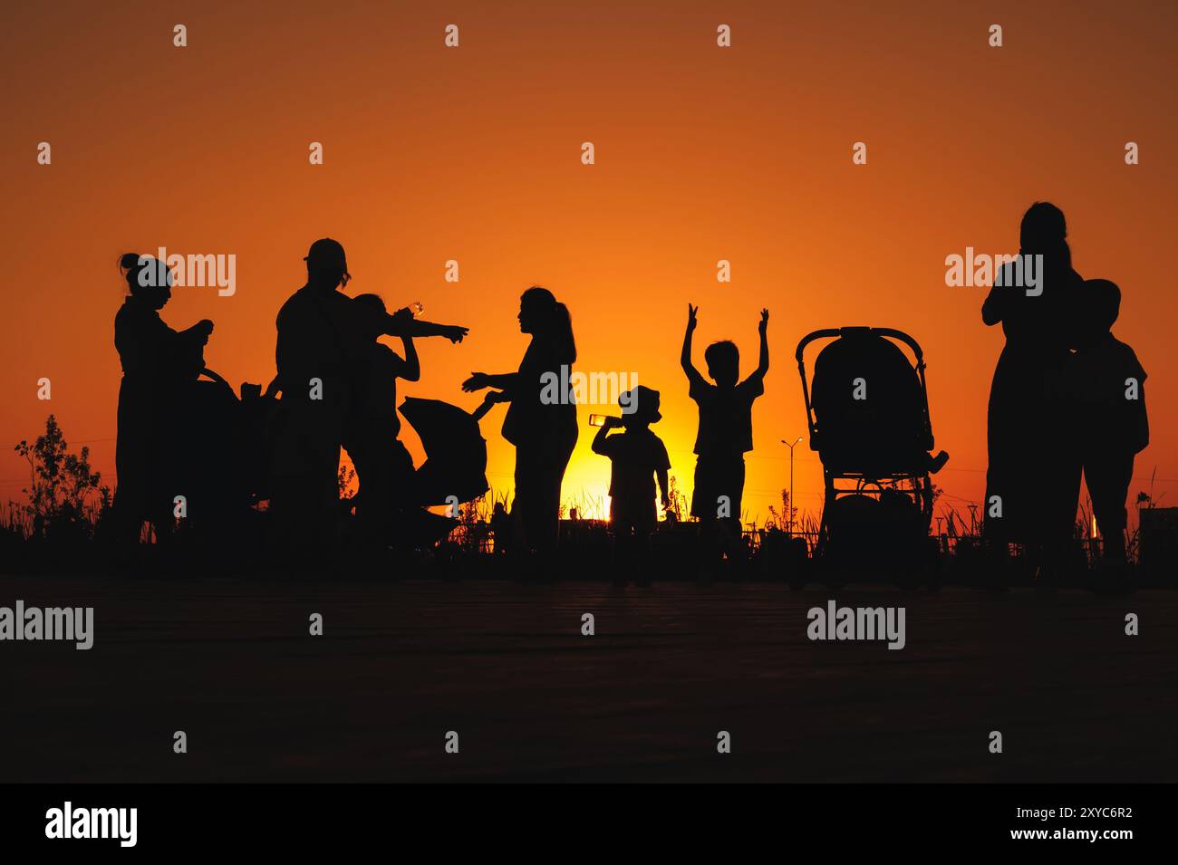 Back view of happy multi generational people having fun in a public ...