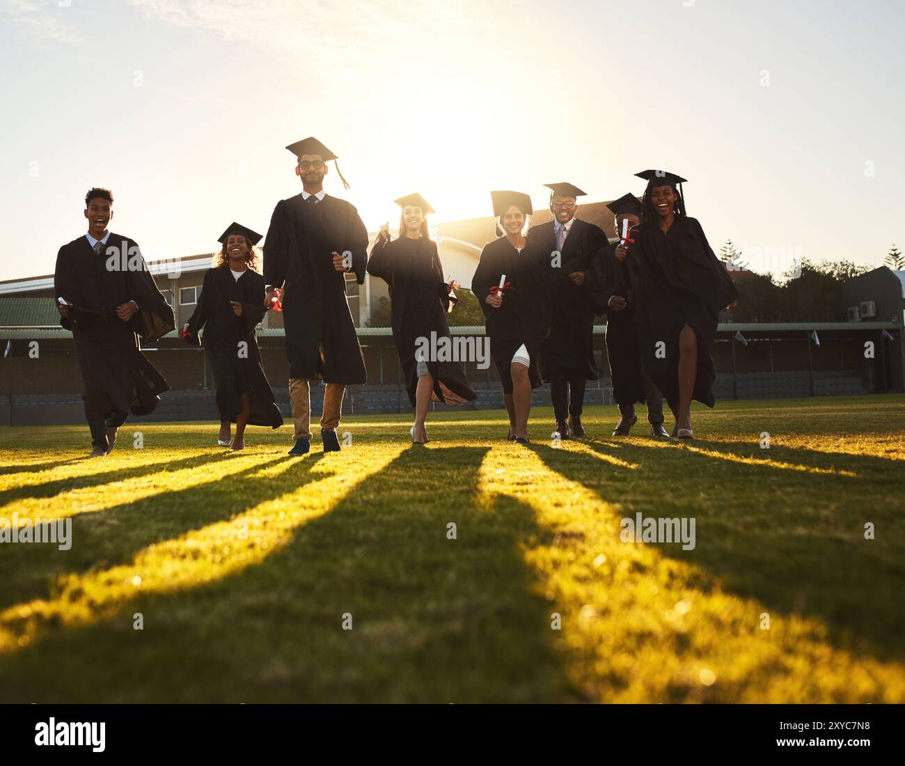 Graduation, group portrait and campus lawn with college success ...