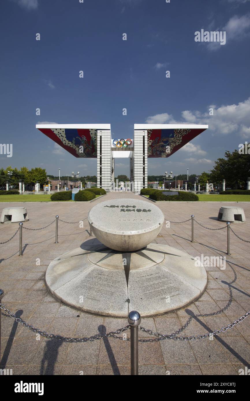 A small memorial stands in front of the eaved World Peace Gate at the ...