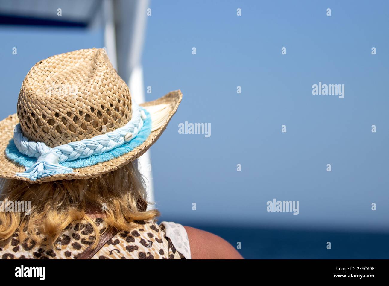A woman on a boat wearing straw hat Stock Photo - Alamy