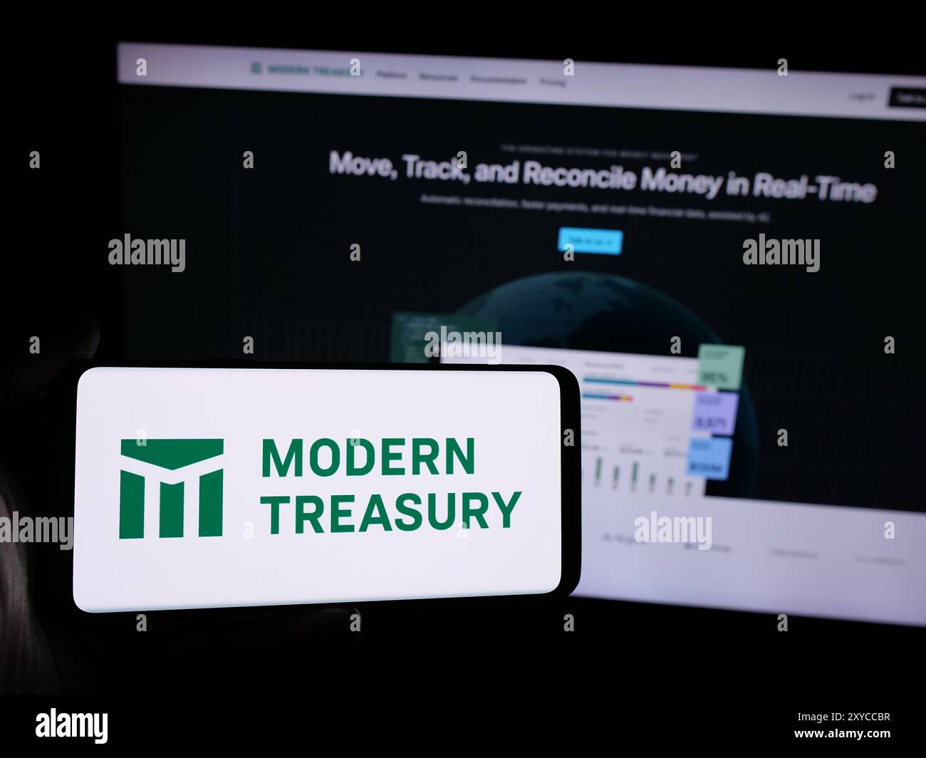 Person holding mobile phone with logo of American money movement ...