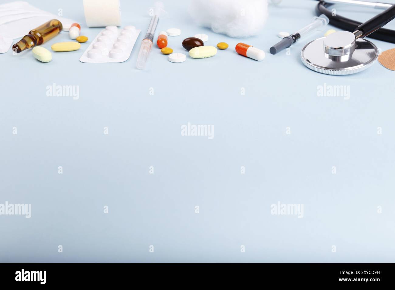 Medical objects flat lay blue background syringes pills and ampoule ...