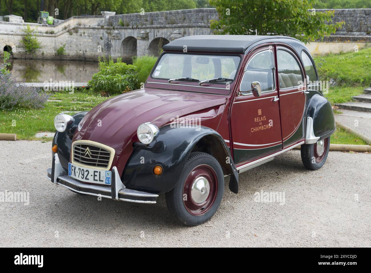 Retro Citroen 2CV vintage car in red and black, parked on a road in ...