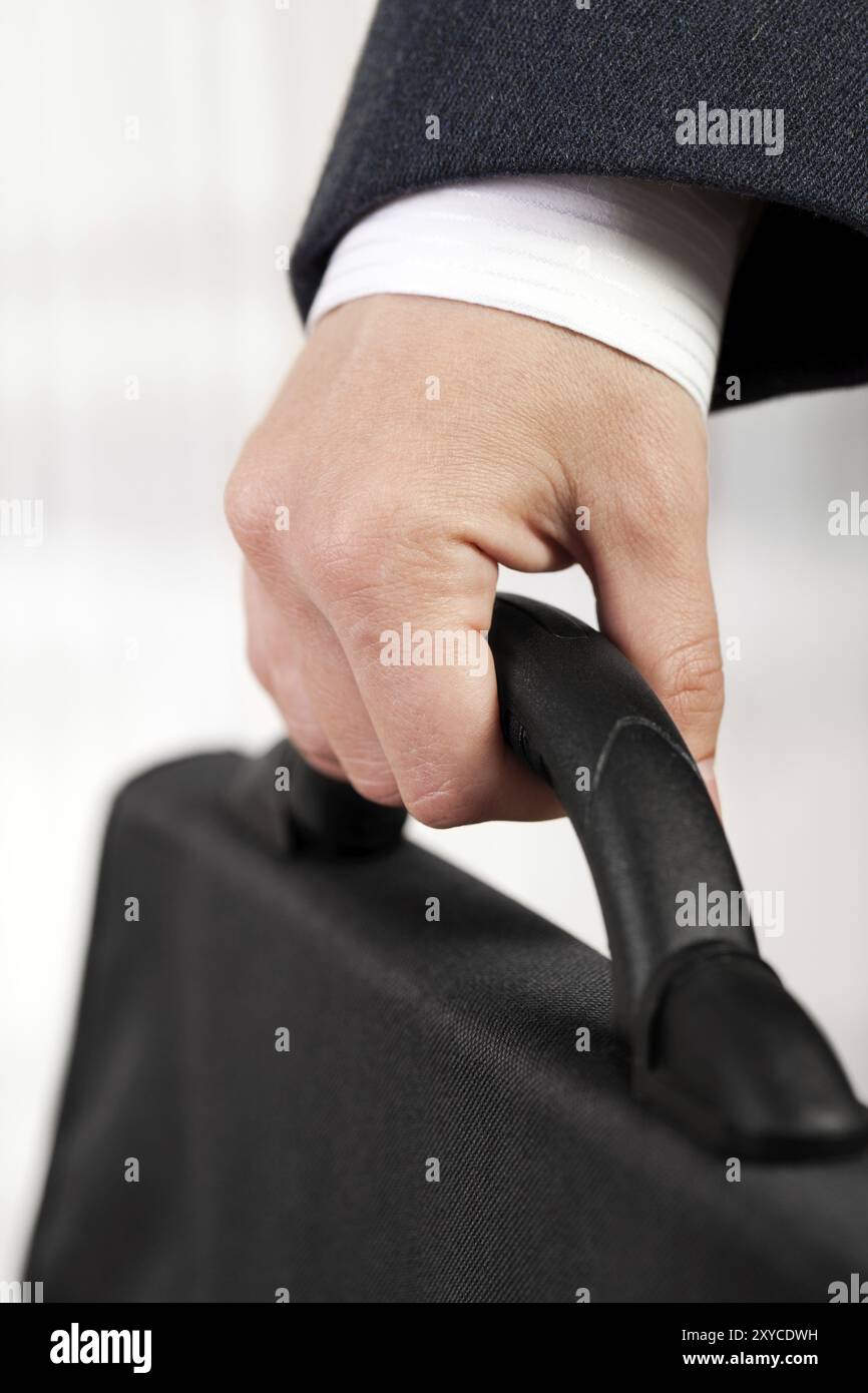 Business men in black suit hand holding briefcase Stock Photo - Alamy