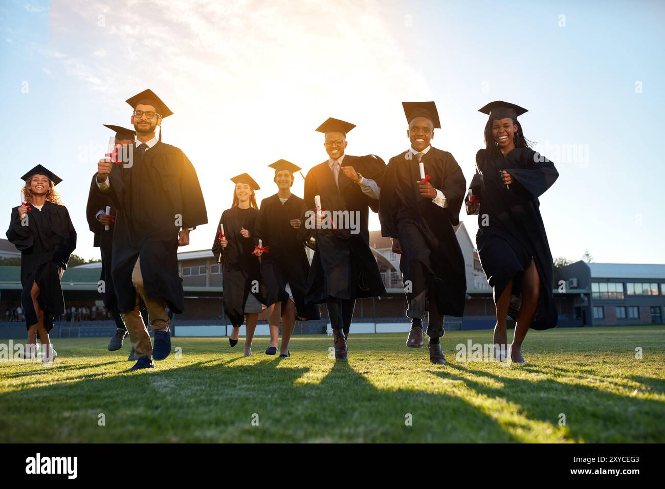Graduation, group run and campus lawn with college success, student ...