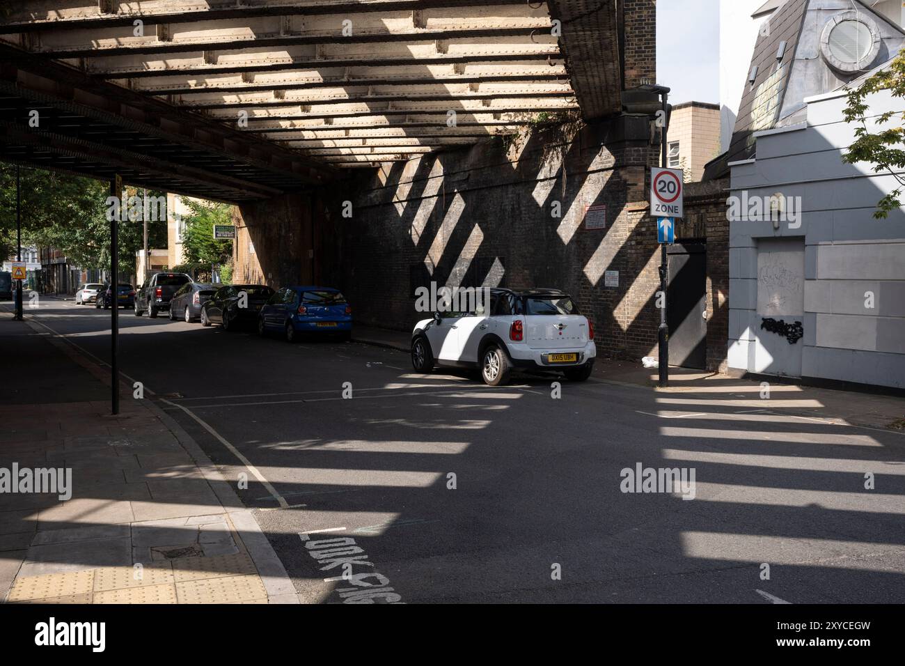 Stripes and angle shadows from an overhead railway bridge are seen ...