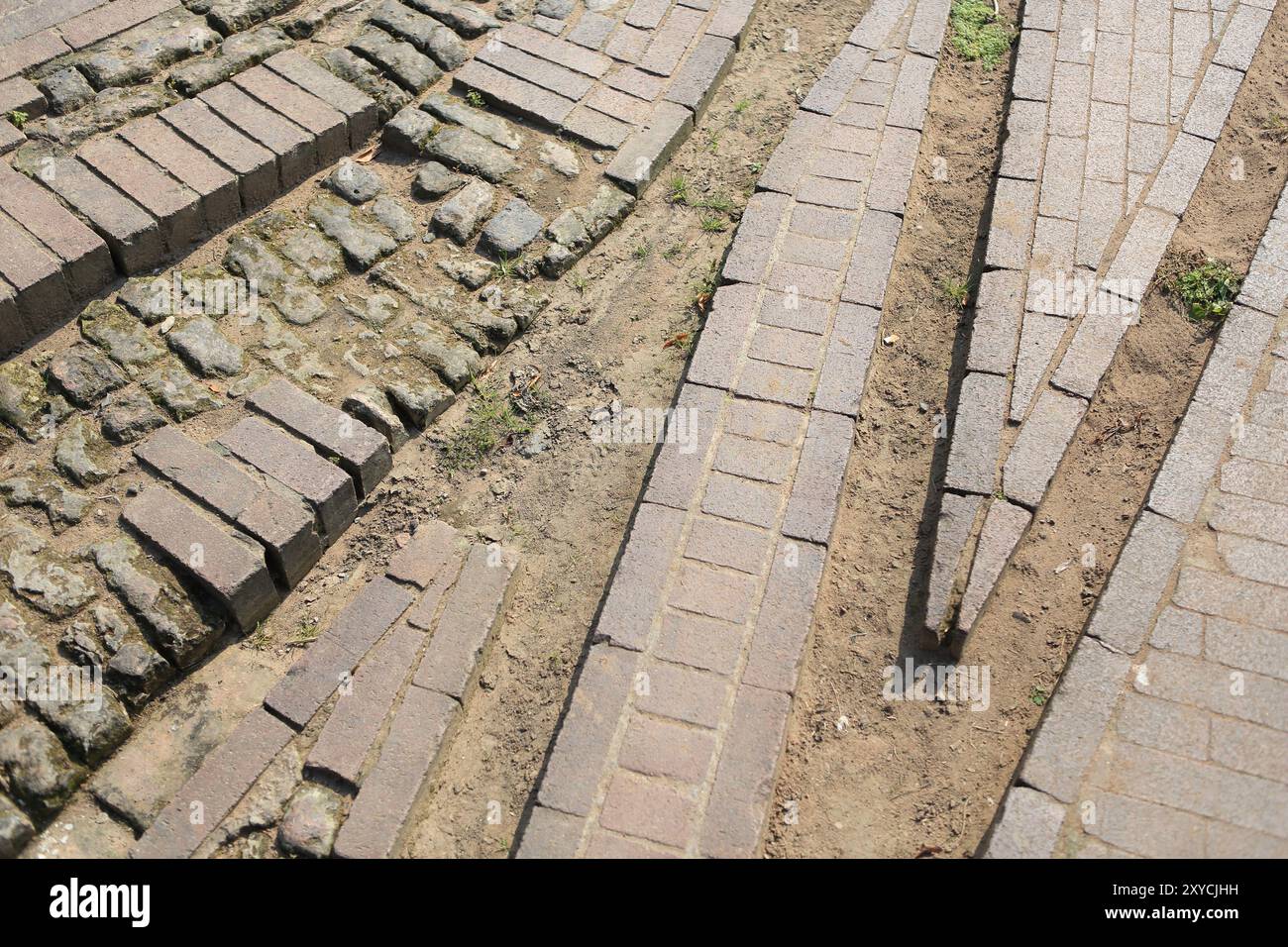 Brickwork on ground showing tracks criss crossing Stock Photo - Alamy