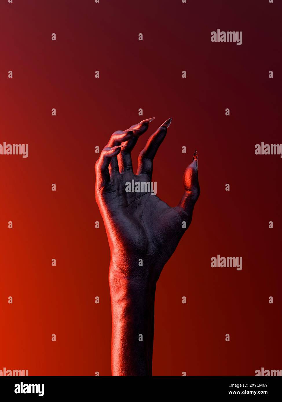 Creepy hand with long black nails is reaching up against a red ...