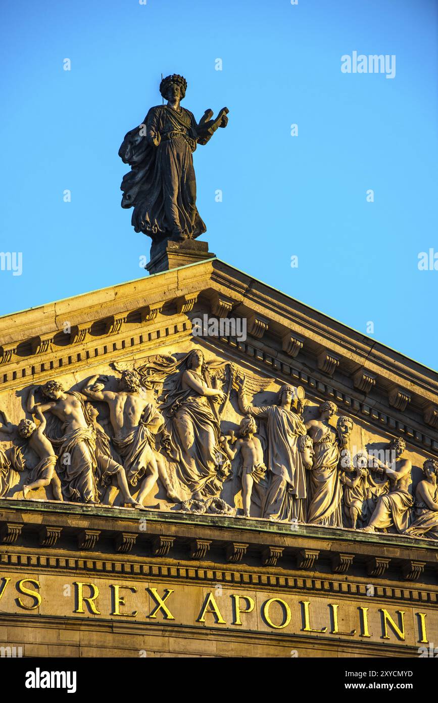 Blackened statue on a sandstone pediment with relief Stock Photo - Alamy