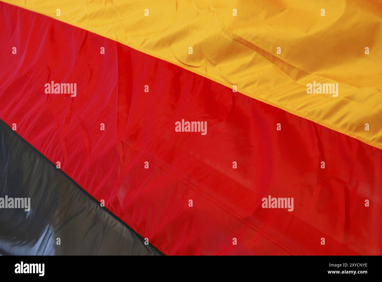 Detail of a big german flag waving in the wind with diagonal stripes ...
