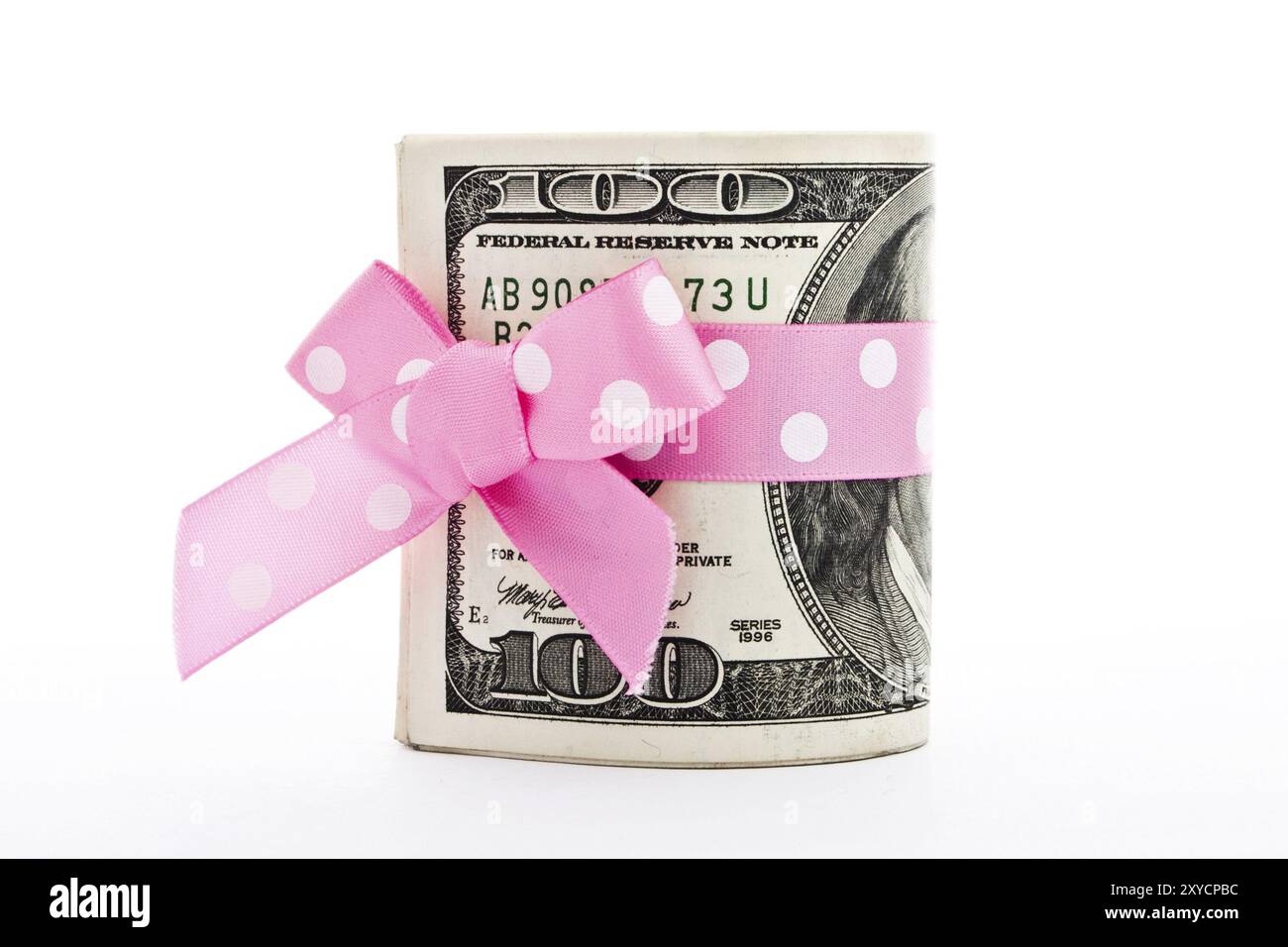 A stack of 100-dollar bills with a holiday bow isolated on white Stock ...