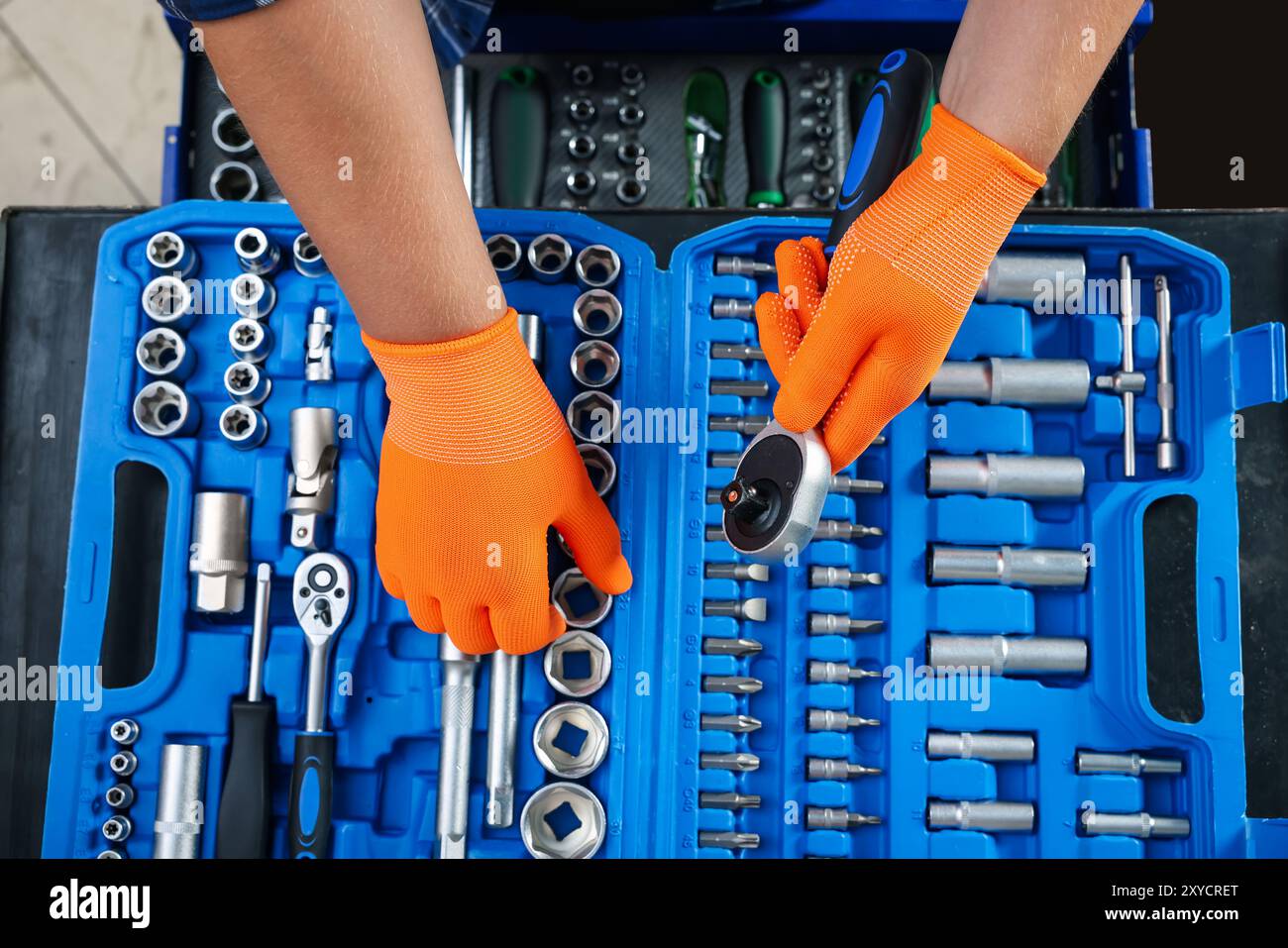 Auto mechanic with torque wrench and different tools at automobile ...