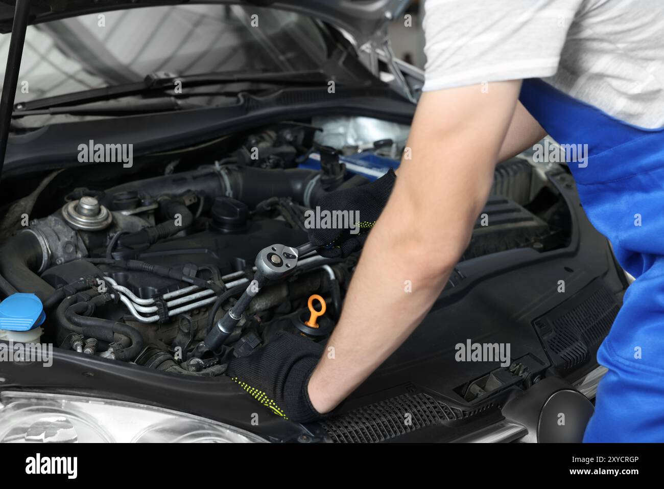 Auto mechanic fixing car at automobile repair shop, closeup Stock Photo ...