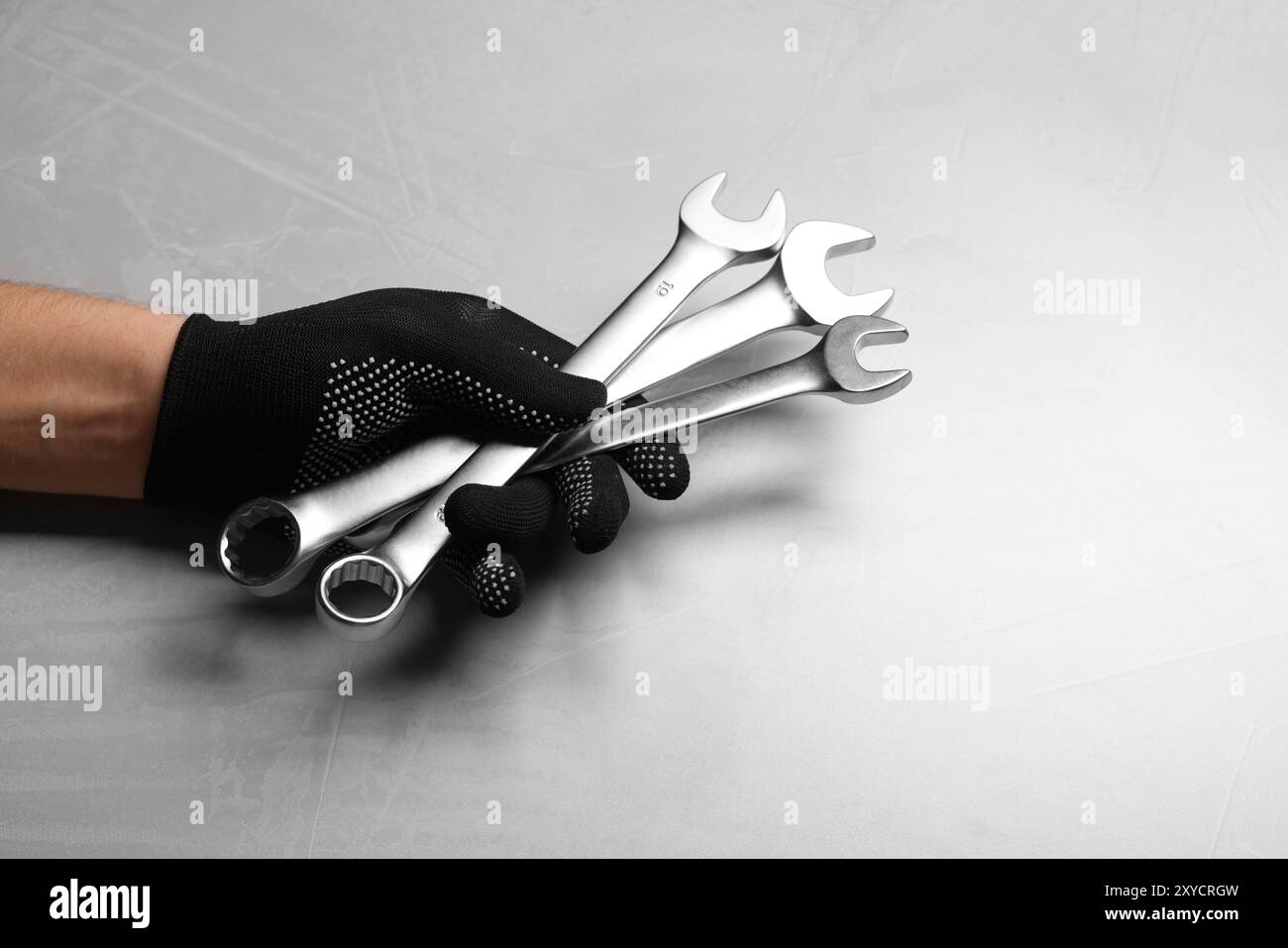 Auto mechanic with wrenches at light grey textured table, closeup Stock ...