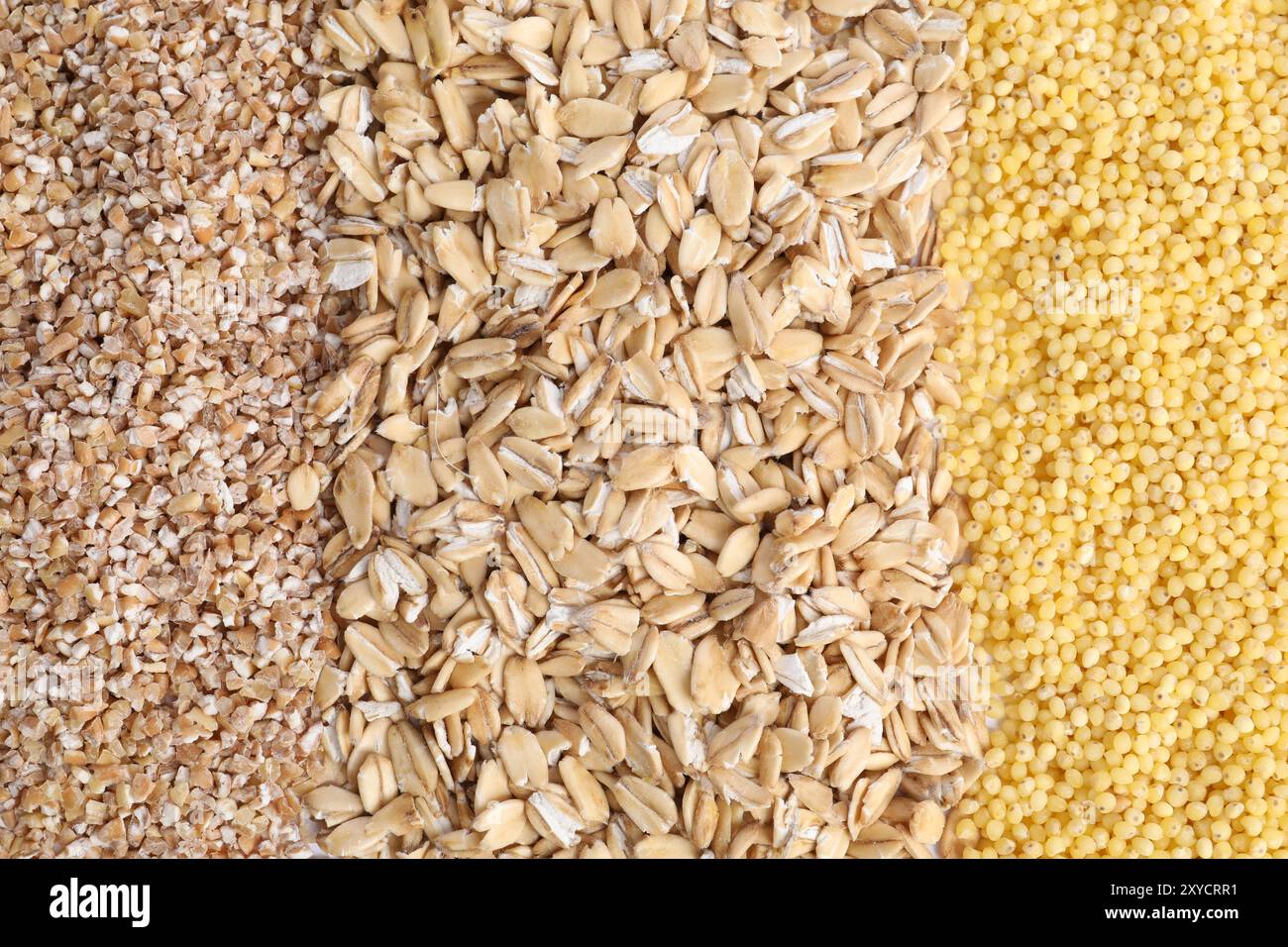 Oat flakes, wheat and millet groats as background, top view Stock Photo ...