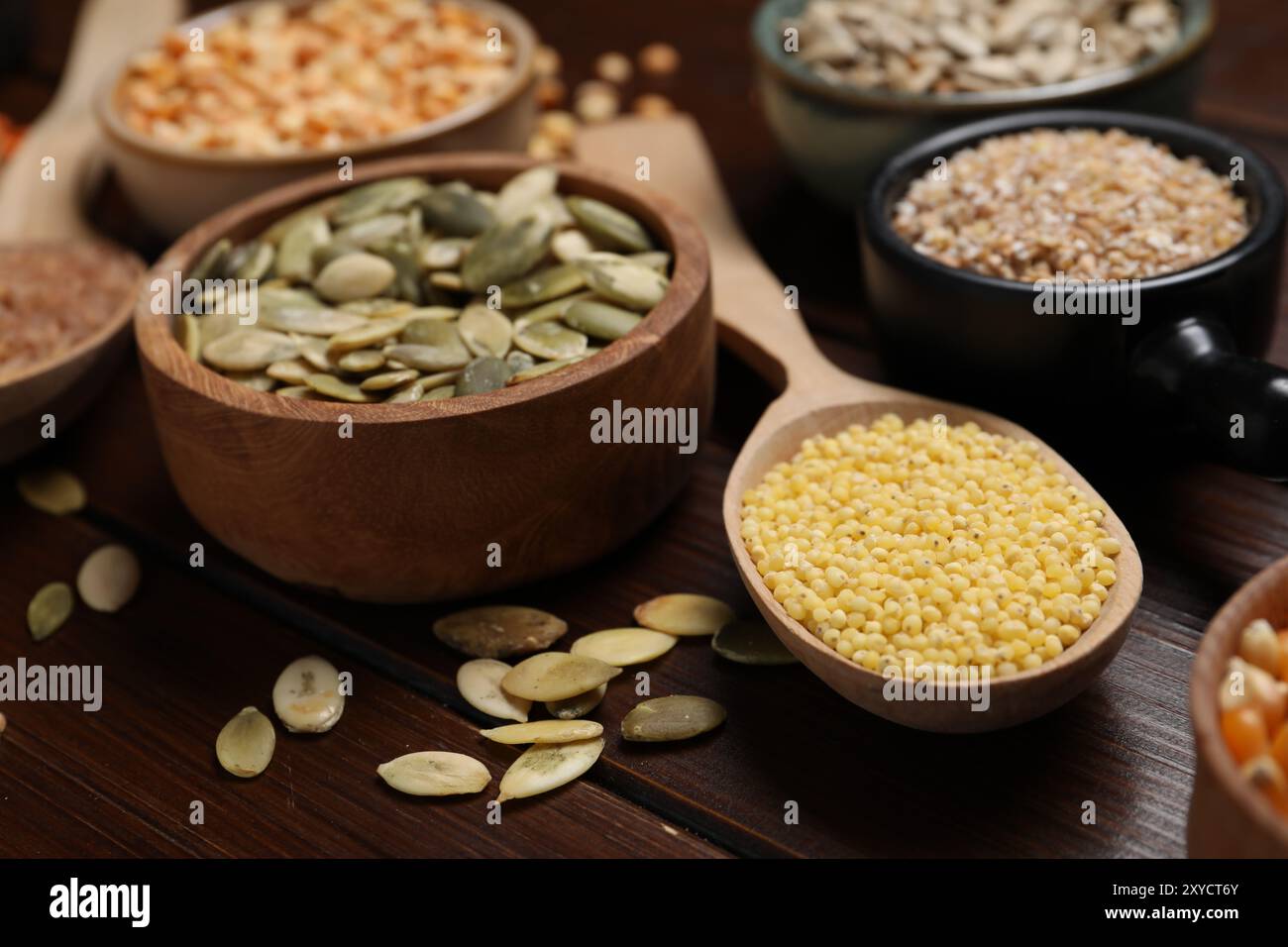 Different types of seeds and cereals on wooden table, closeup Stock ...