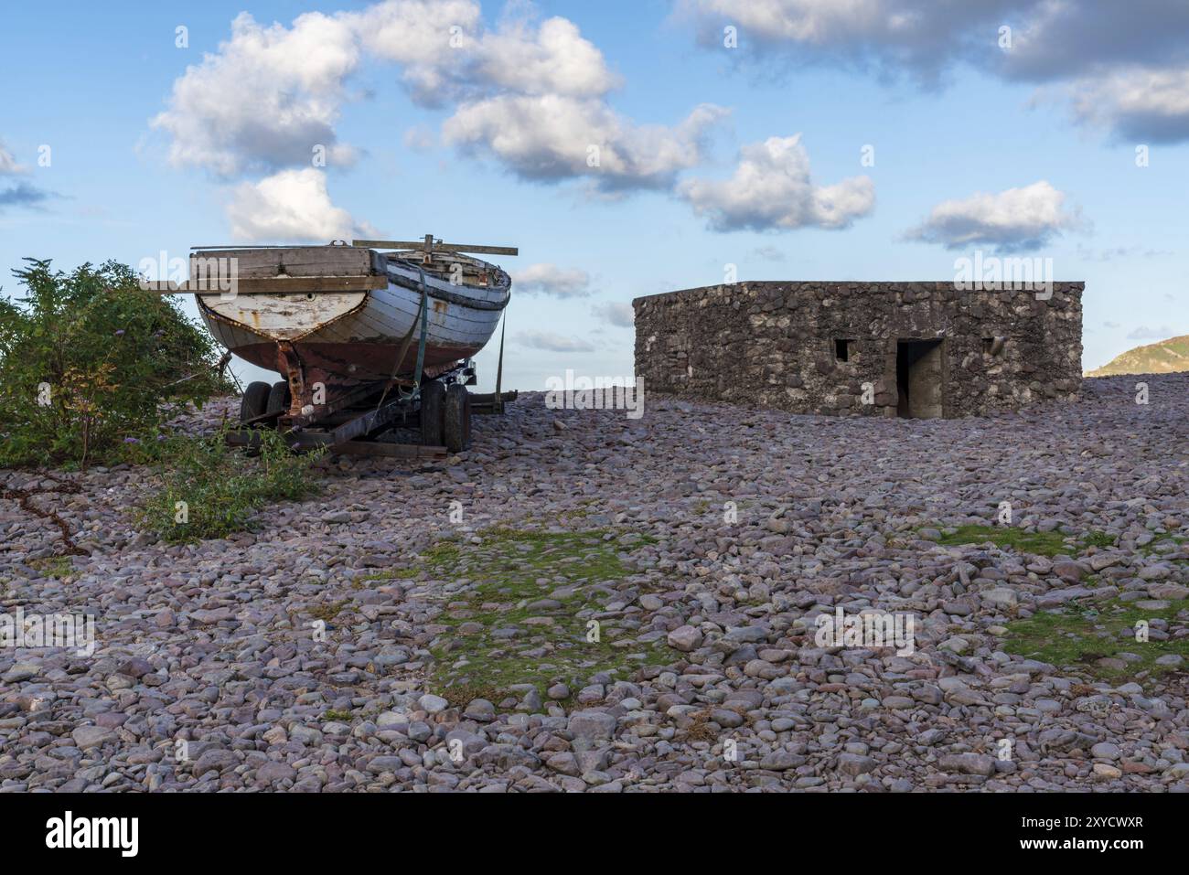 The pebble beach in Porlock Weir, Somerset, England, UK, with a boat ...