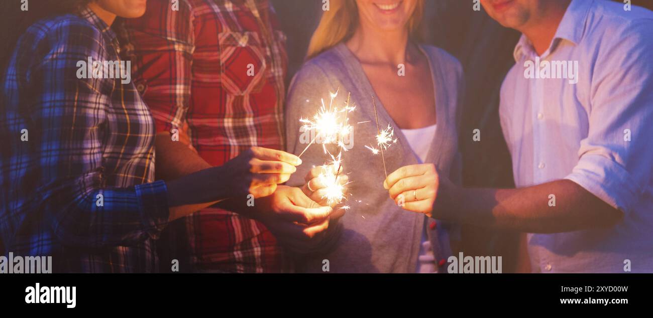 Group of anonymous people in casual clothes burning bright sparkles ...