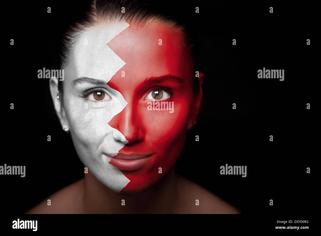 Portrait of a woman with the flag of the Bahrain painted on her face ...