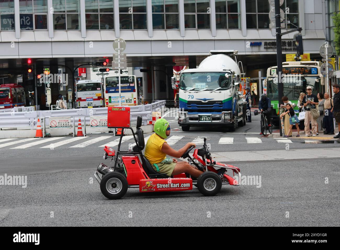TOKYO, JAPAN - August 22, 2024: A tourist driving a rental go-cart over ...