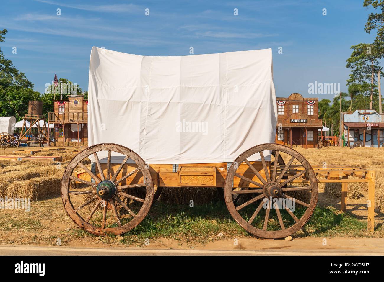 Antique covered wagon in the old west city Stock Photo - Alamy