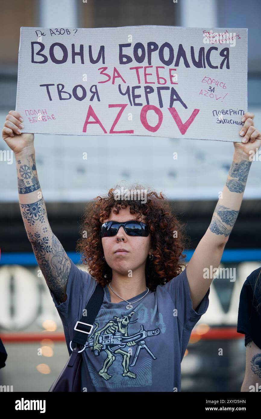 Ukrainian activist demonstrating with a sign "They Fought For You. Now It Is Your Turn. Free ...