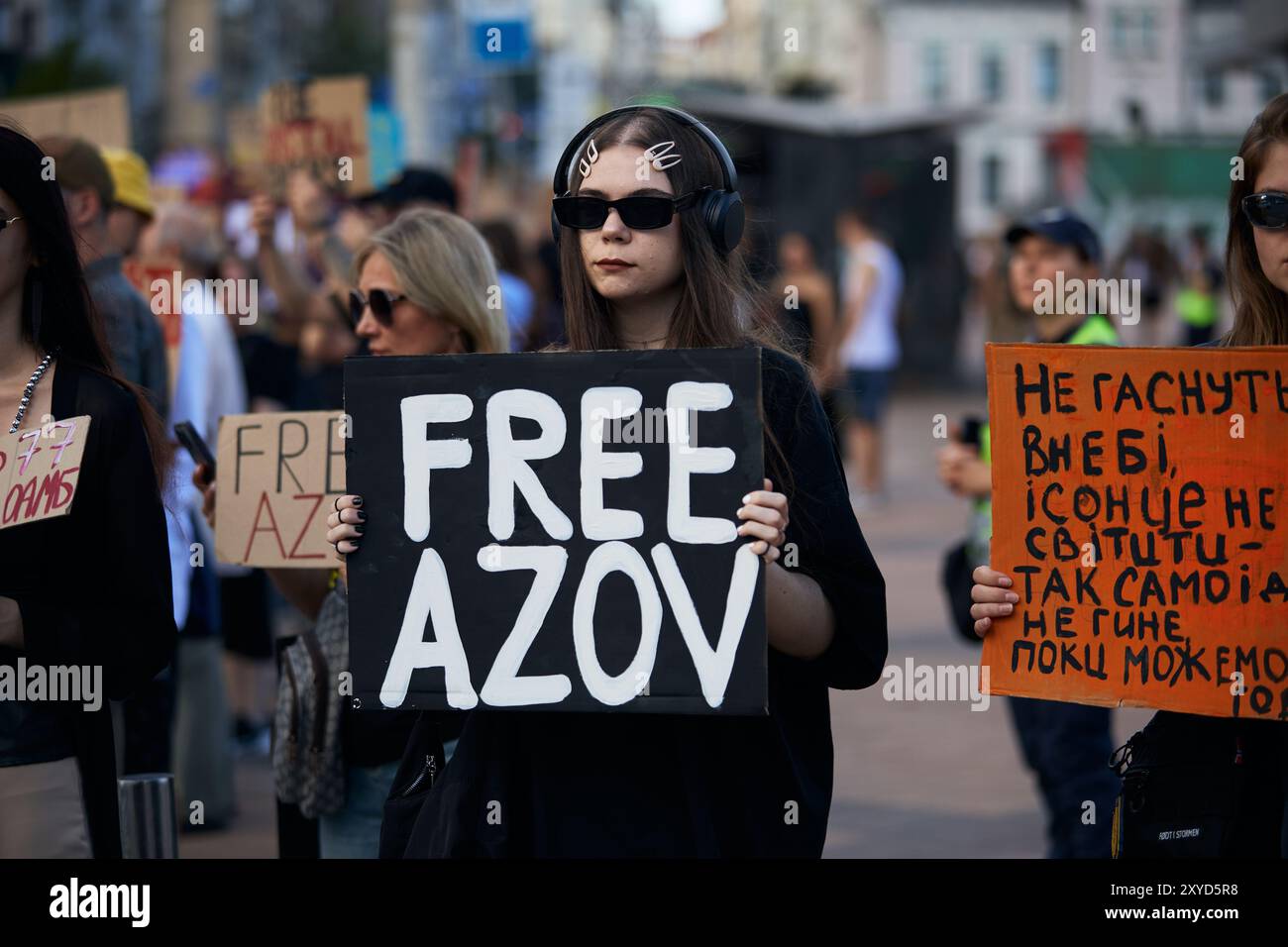 Young Ukrainian girl demonstrating with a sign Free Azov in center of ...