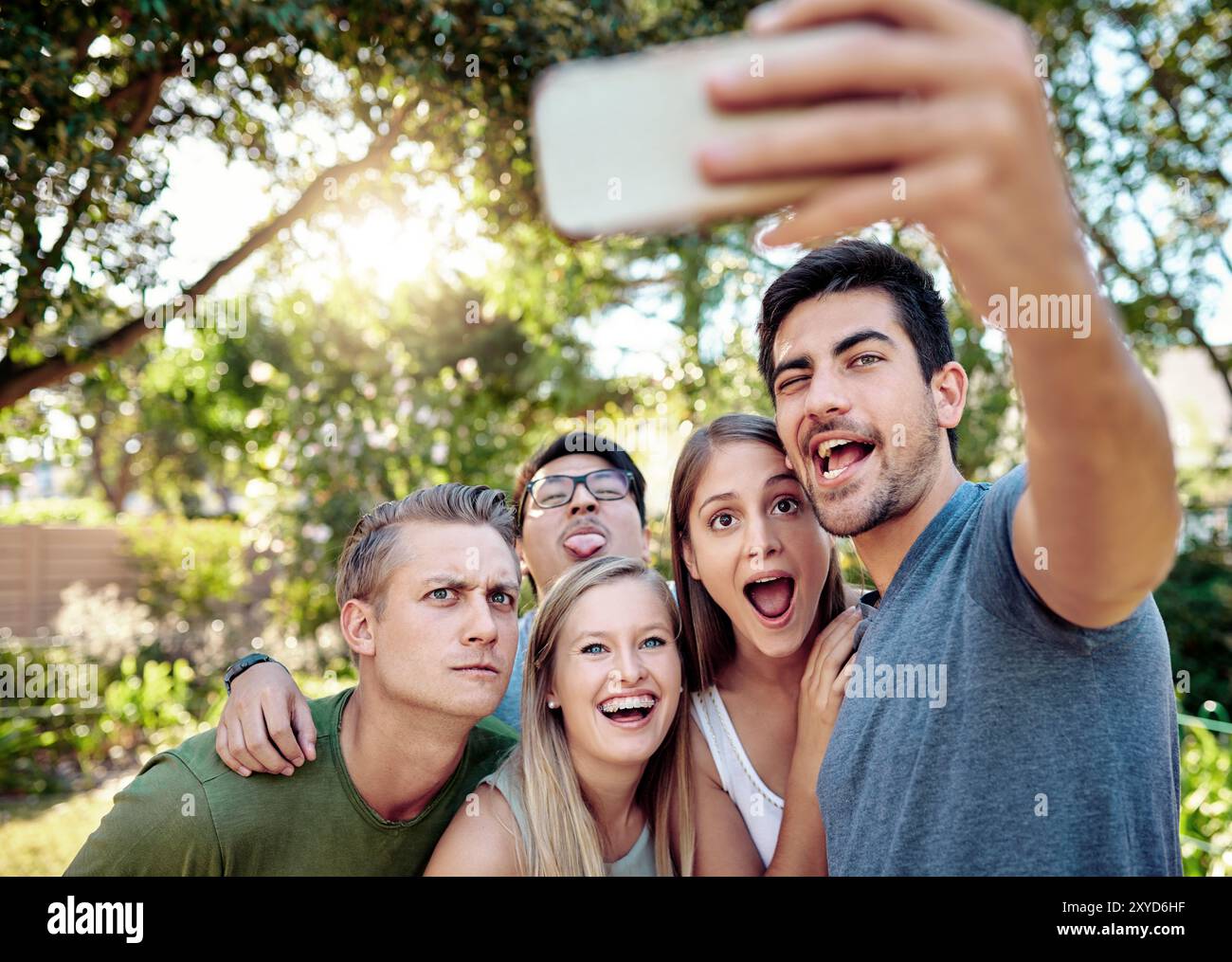 Funny face, humor and selfie with group of friends outdoor in nature ...