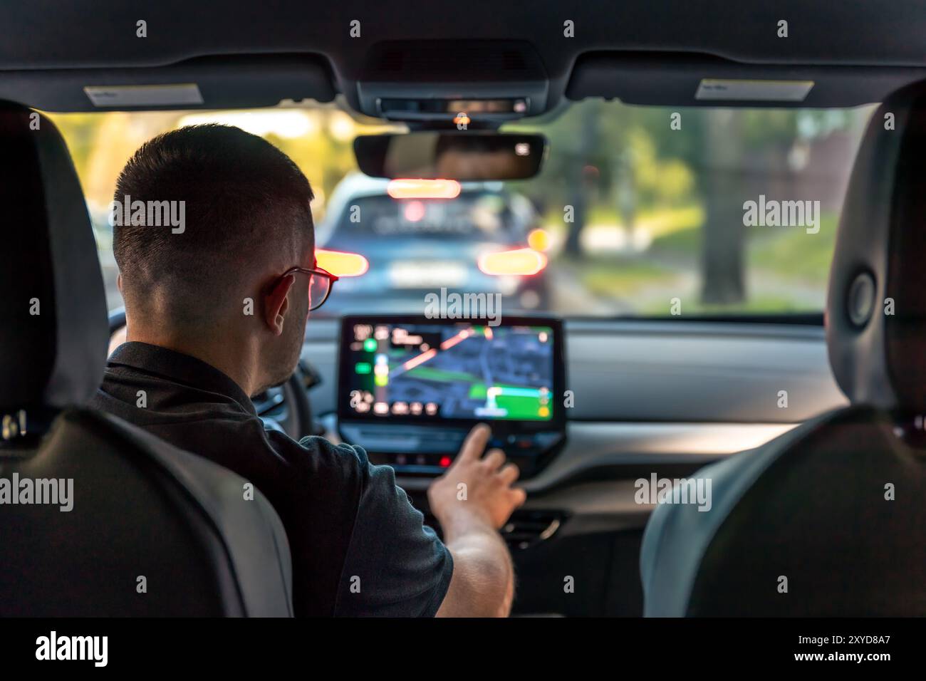 Man touching screen of a GPS navigation system in his car Stock Photo ...