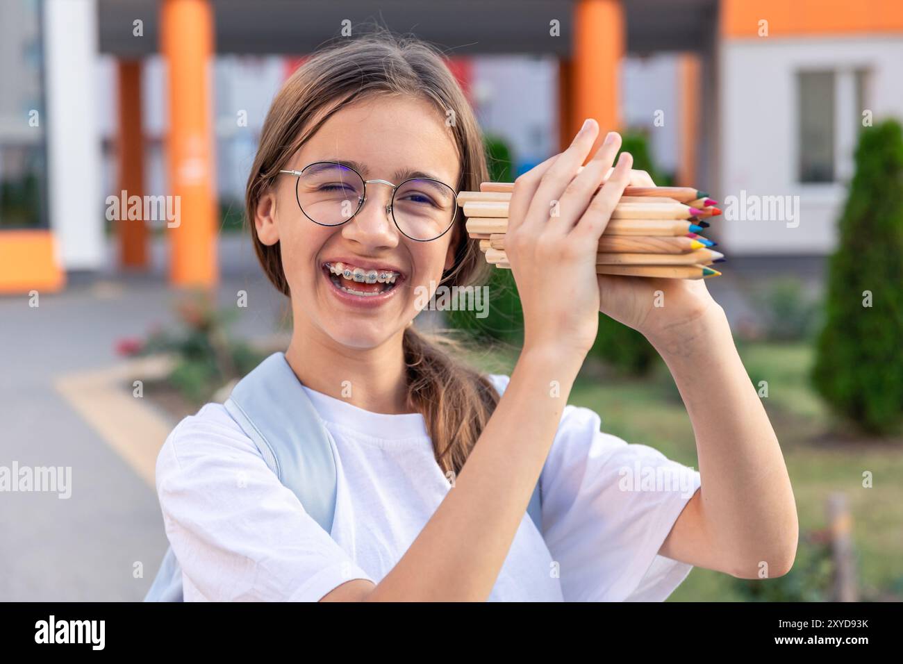 Schoolgirl with pencils in hands close-up. Student with school supplies ...