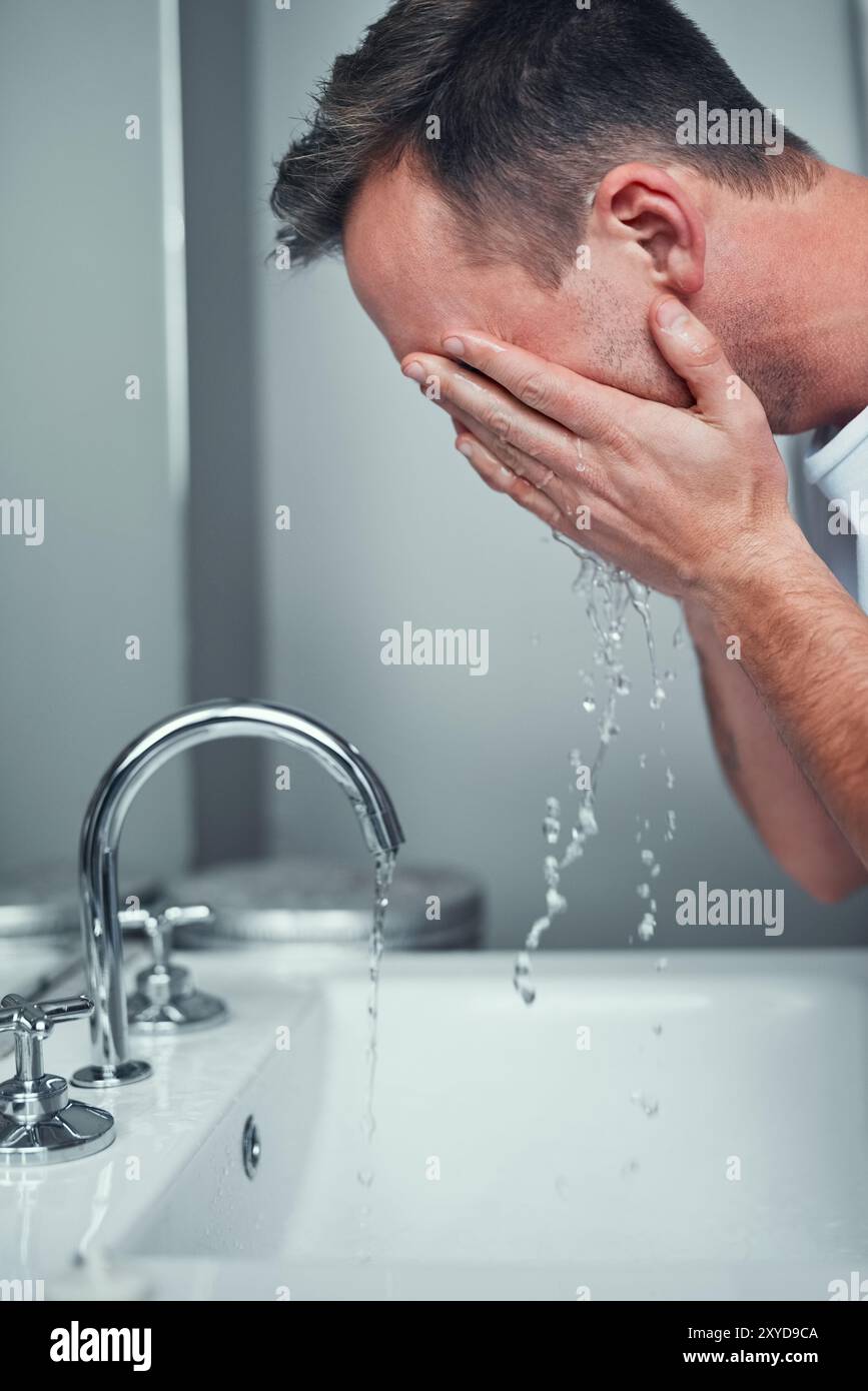 Cleaning, man and washing face in bathroom for health, hygiene and ...