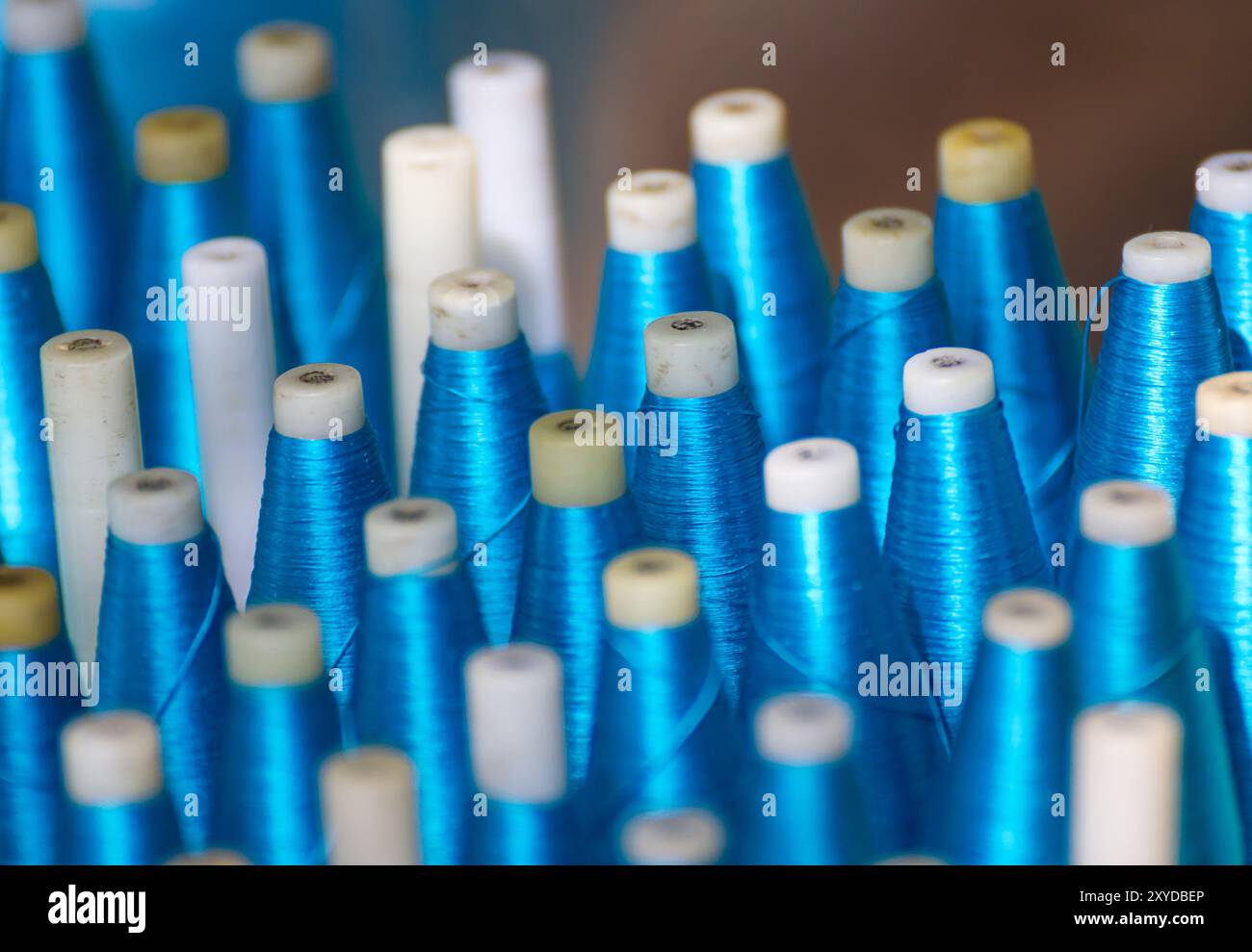 Bobbin for weaving silk,Spool of blue silk thread in row Stock Photo ...