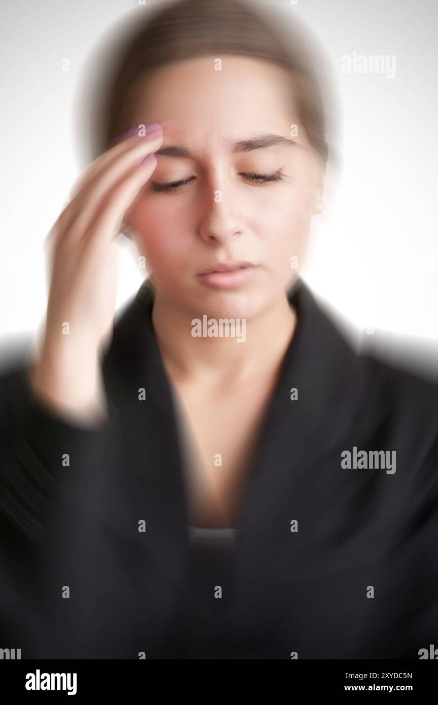 Business woman suffering from an headache, holding her hand to the head ...