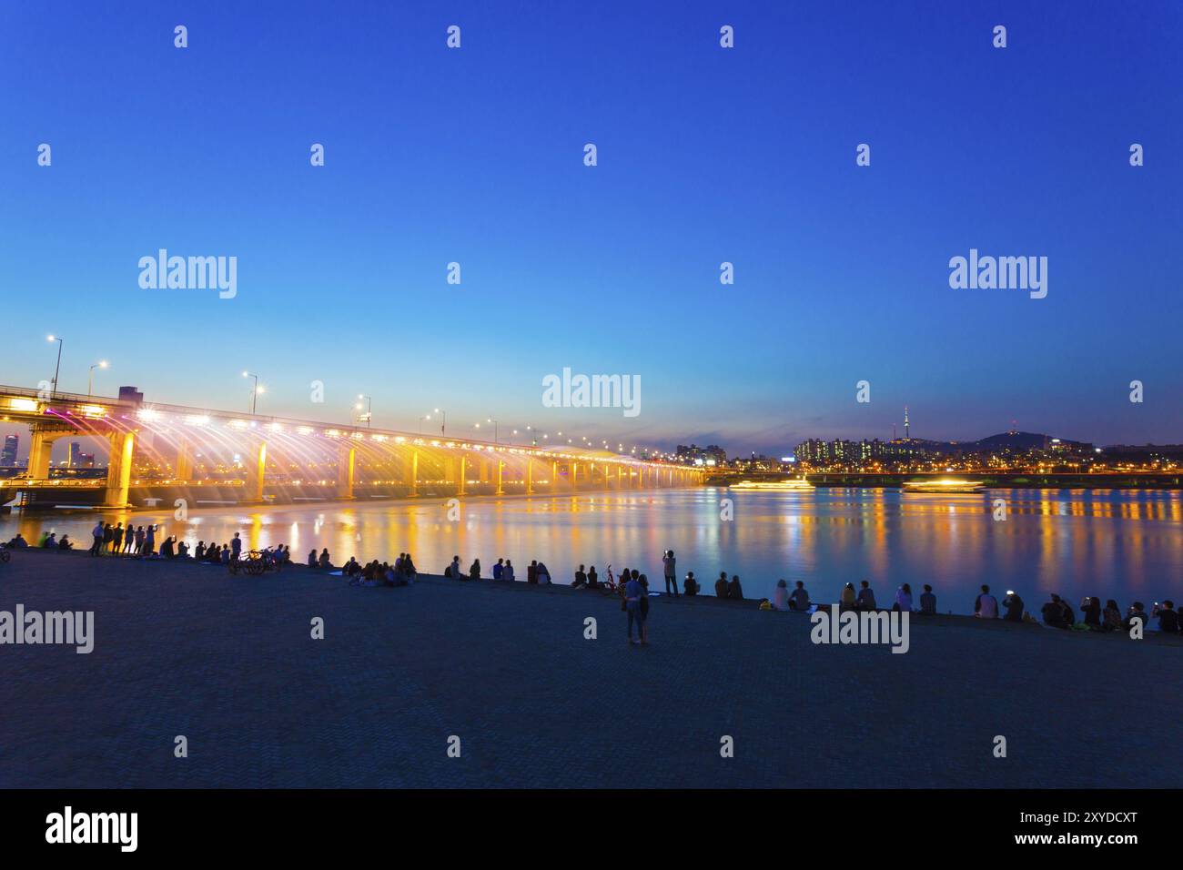 People watching Moonlight Rainbow water fountain and colorful light ...