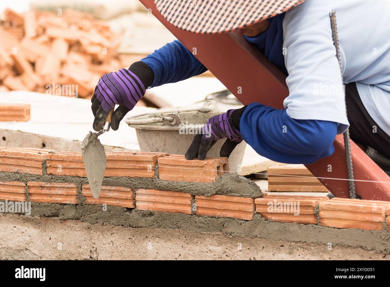 Bricklayer working in construction site of a brick wall. Bricklayer ...